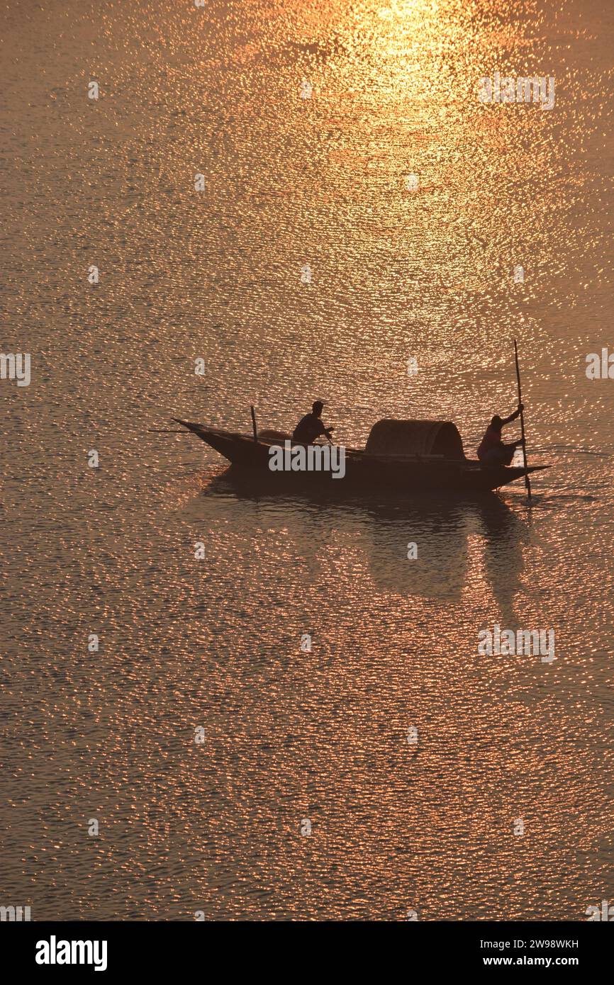A boat on the golden river. Fishermen are fishing in the river at dawn ...