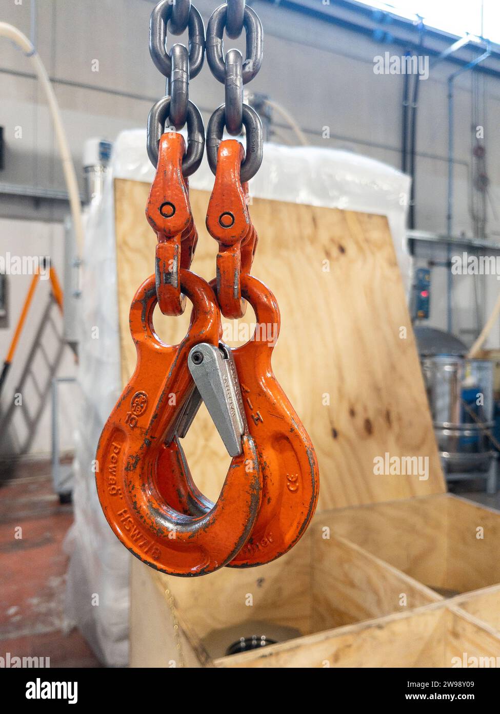 Orange crane hook in factory background. Caserta, Italy Stock Photo - Alamy