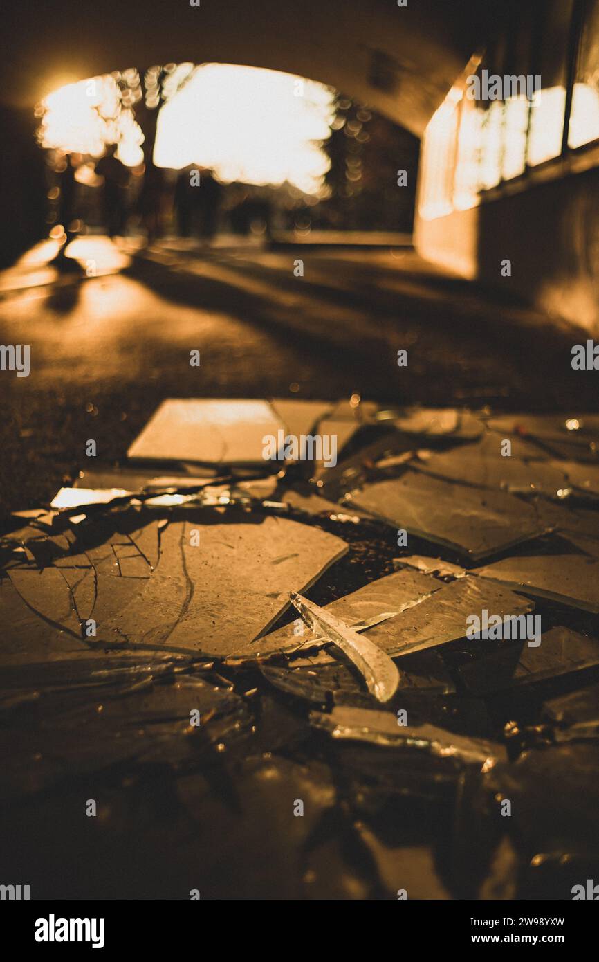A close-up shot of broken and shattered glass windows on the side of a ...