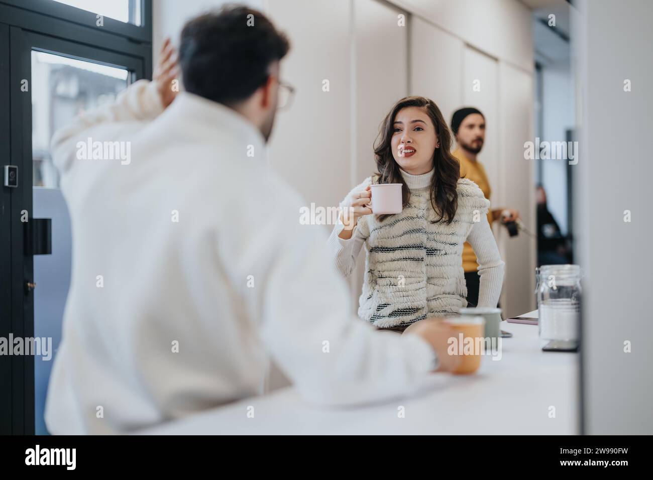 Employees collaborating in a modern kitchen. They discuss ideas and ...