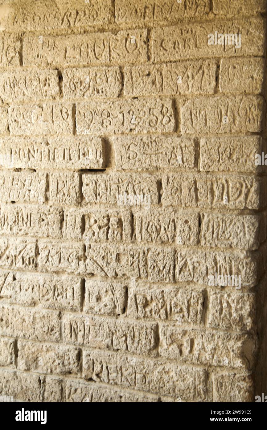 A large stone plaque featuring ancient inscriptions displayed on a wall ...