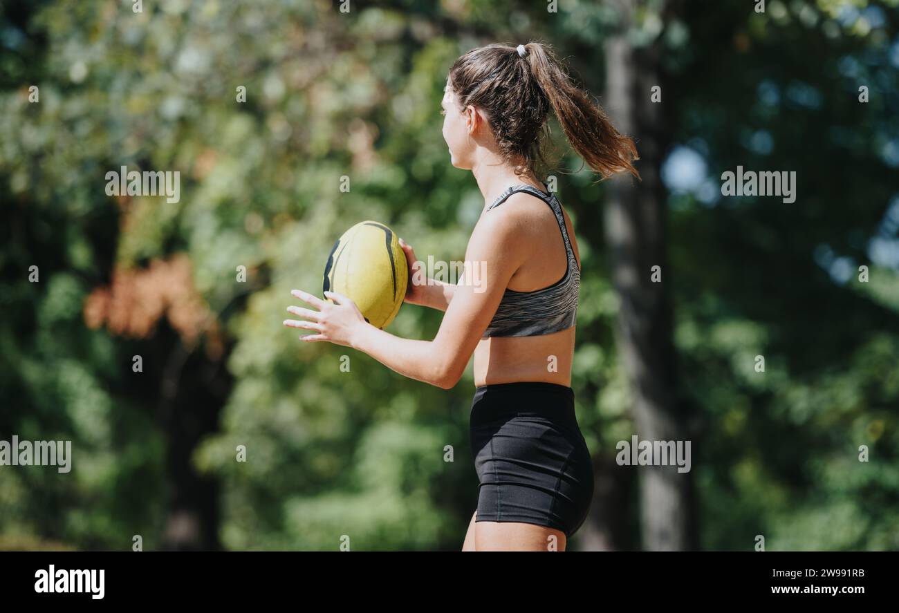 Athletes Having Fun Throwing Ball in a Sunny Park Stock Photo - Alamy