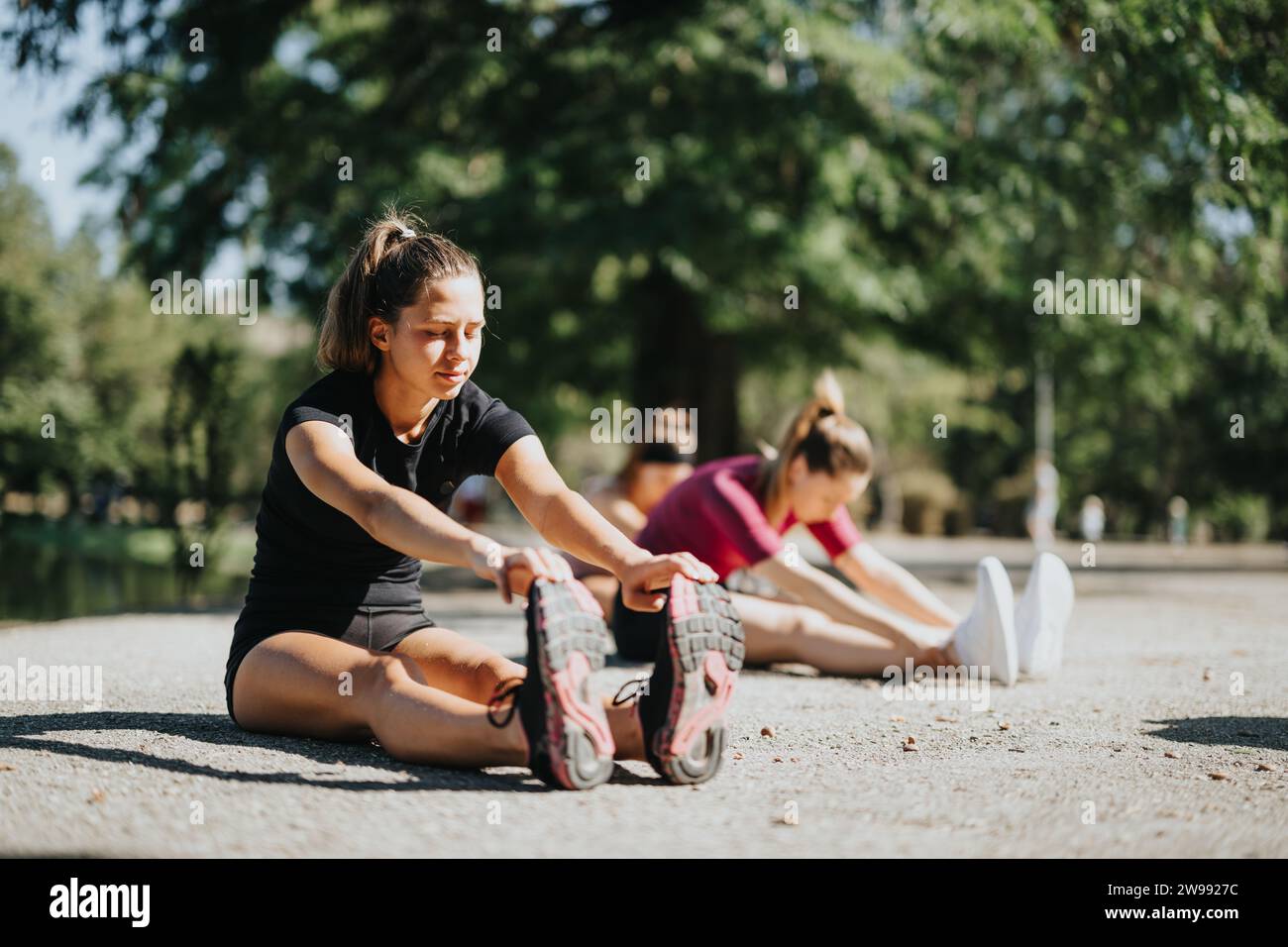 Active Females Enjoying Pre-Workout Warm up Exercises in a Sunny City ...