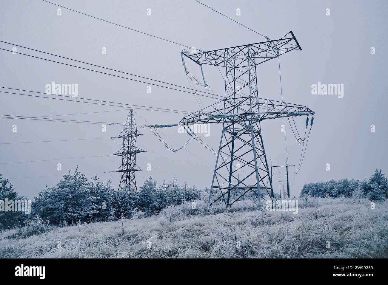 Electric voltage tower, power line, electricity pylon at winter snow ...