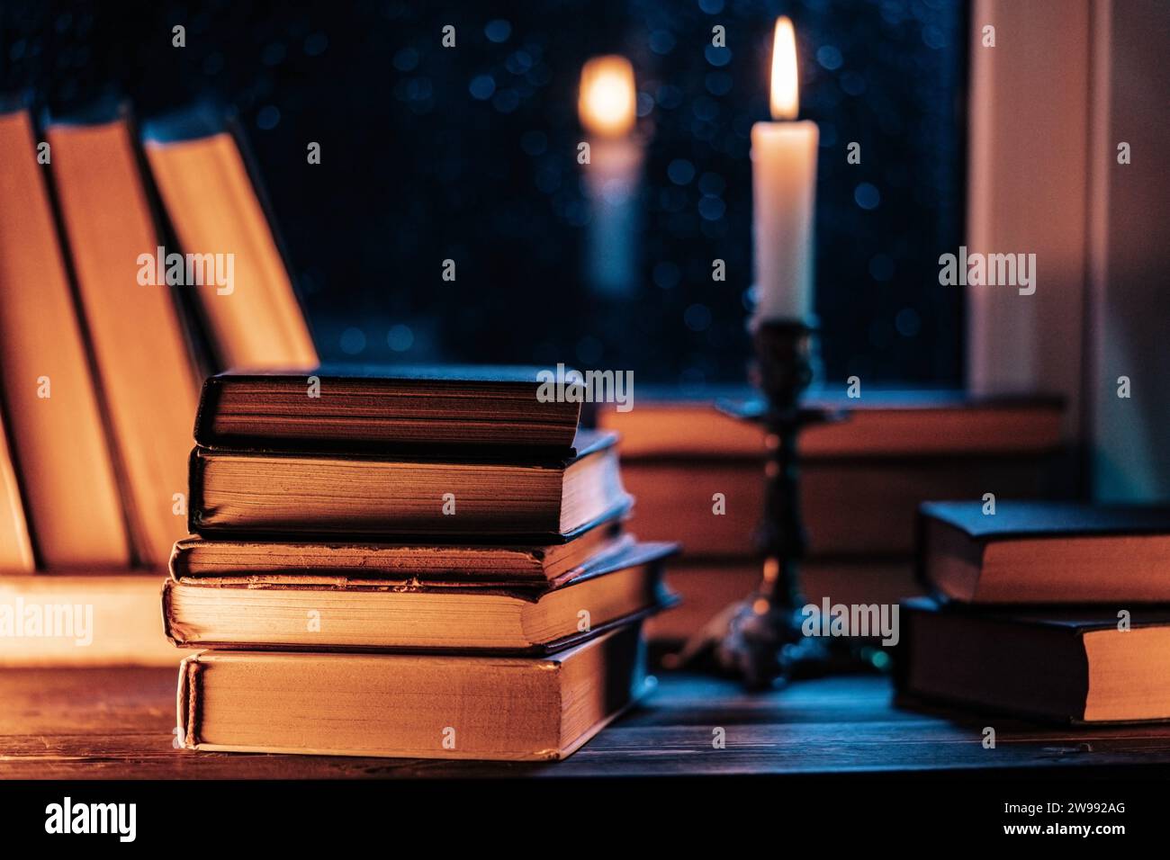 Vintage background. Stack of paper books near rainy window. Bronze ...