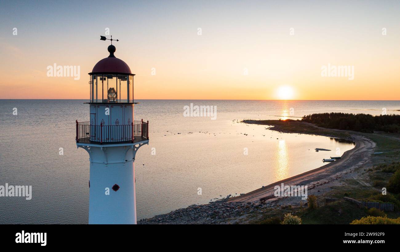 An Aerial view to the top of the historic lighthouse on the setting sun ...