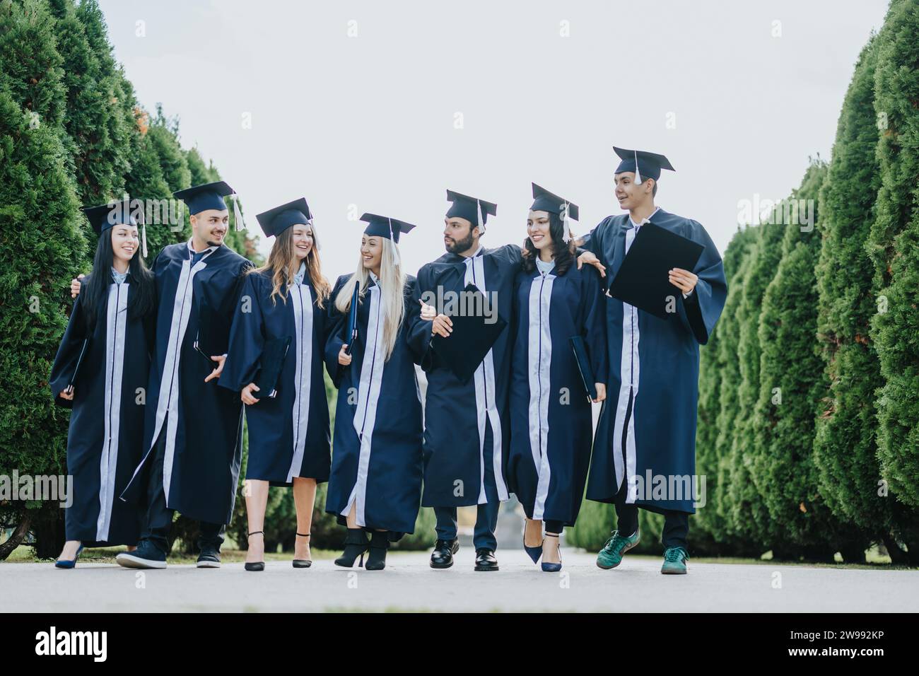 Graduated students celebrate achievements, walking and throwing caps in ...