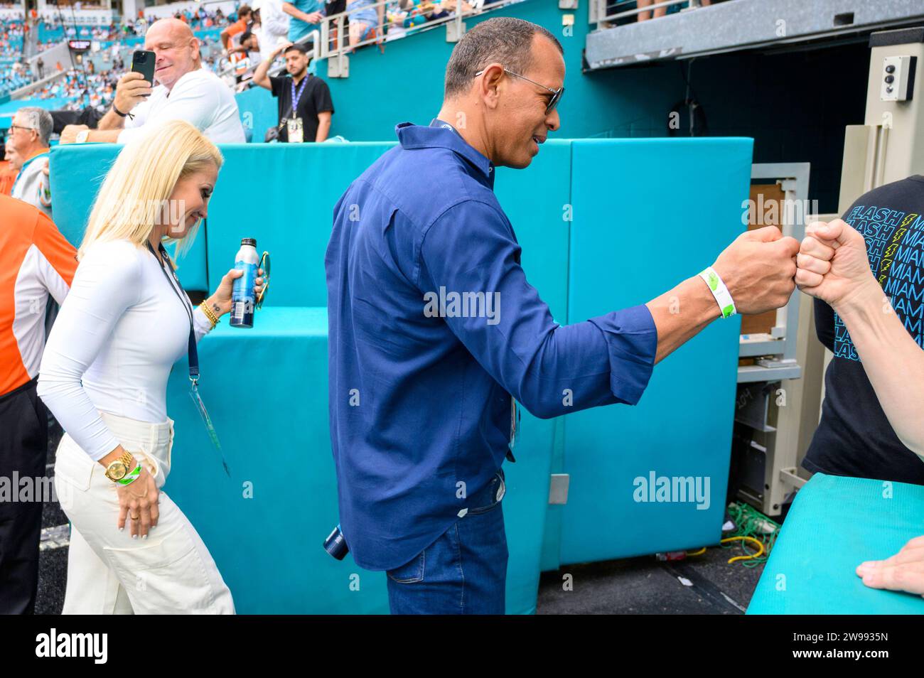 Alex Rodriguez bumps fist with a fan as he leaves the field with his ...