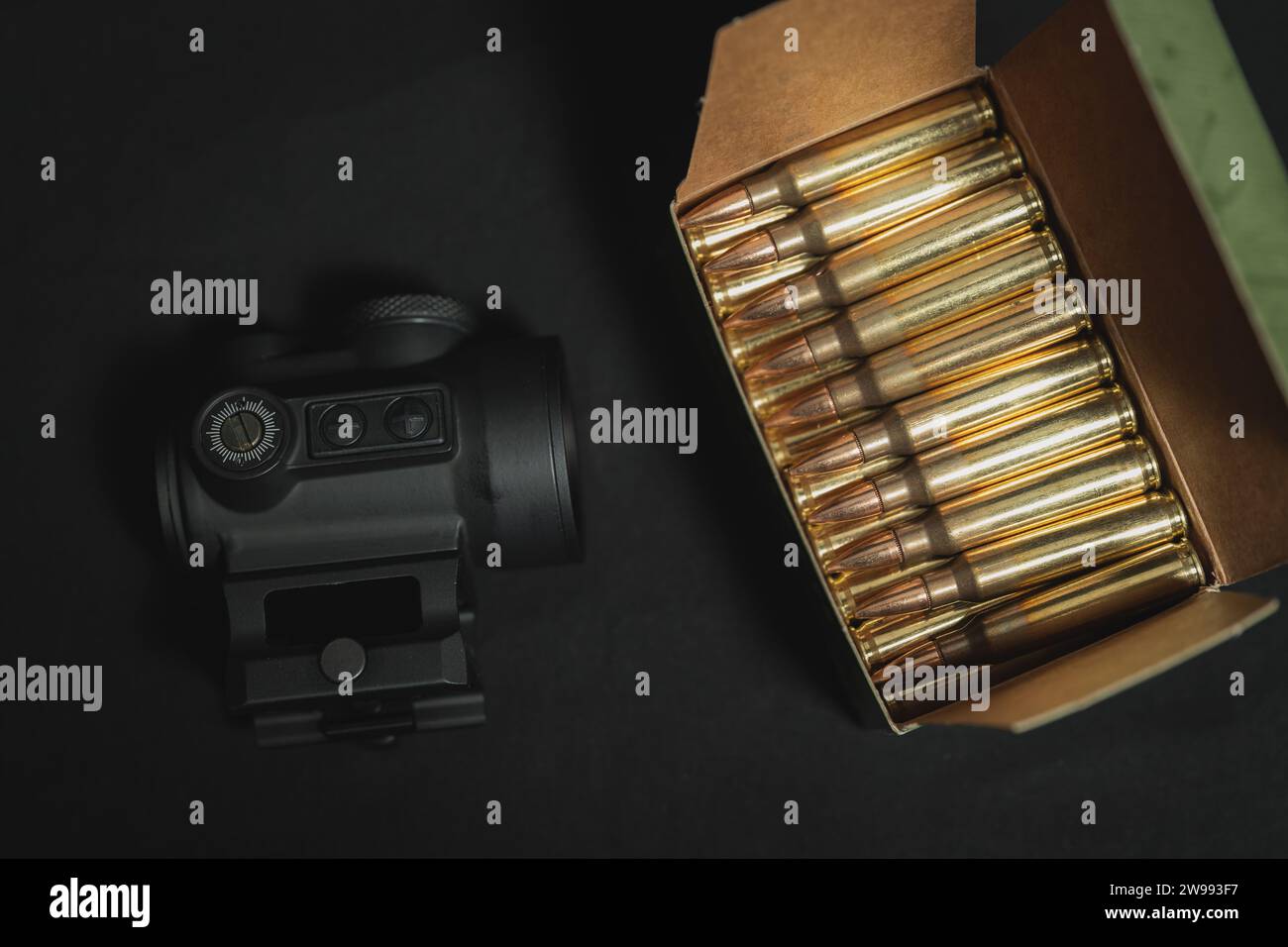 Red dot sight for firearms and 5.56x45mm ammo box, close-up photography ...