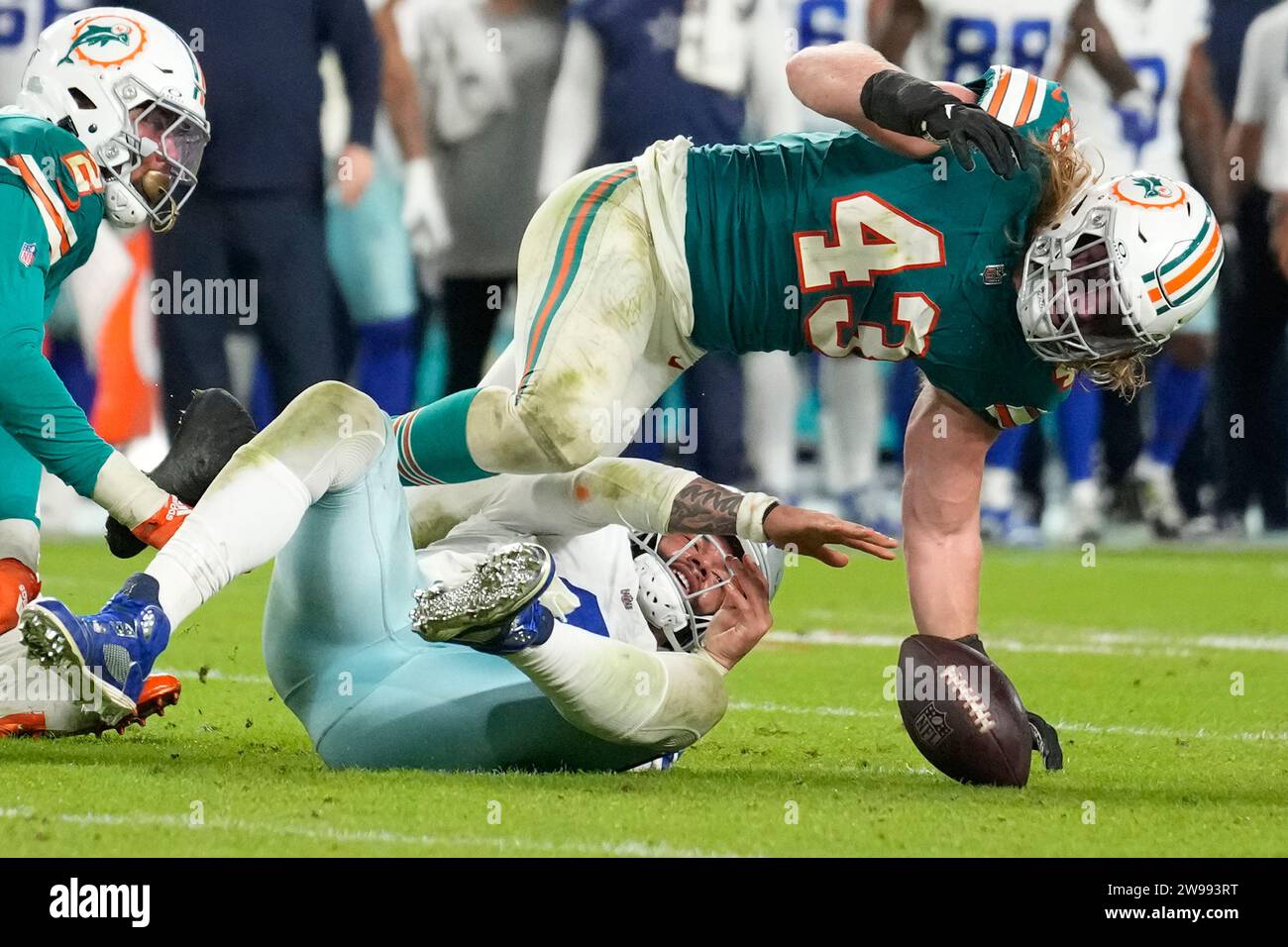 Dallas Cowboys quarterback Dak Prescott, left, loses the football as ...