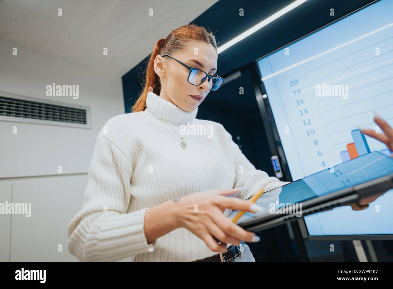 Business training comes alive as the redhead professional unveils charts showcasing sales and ...