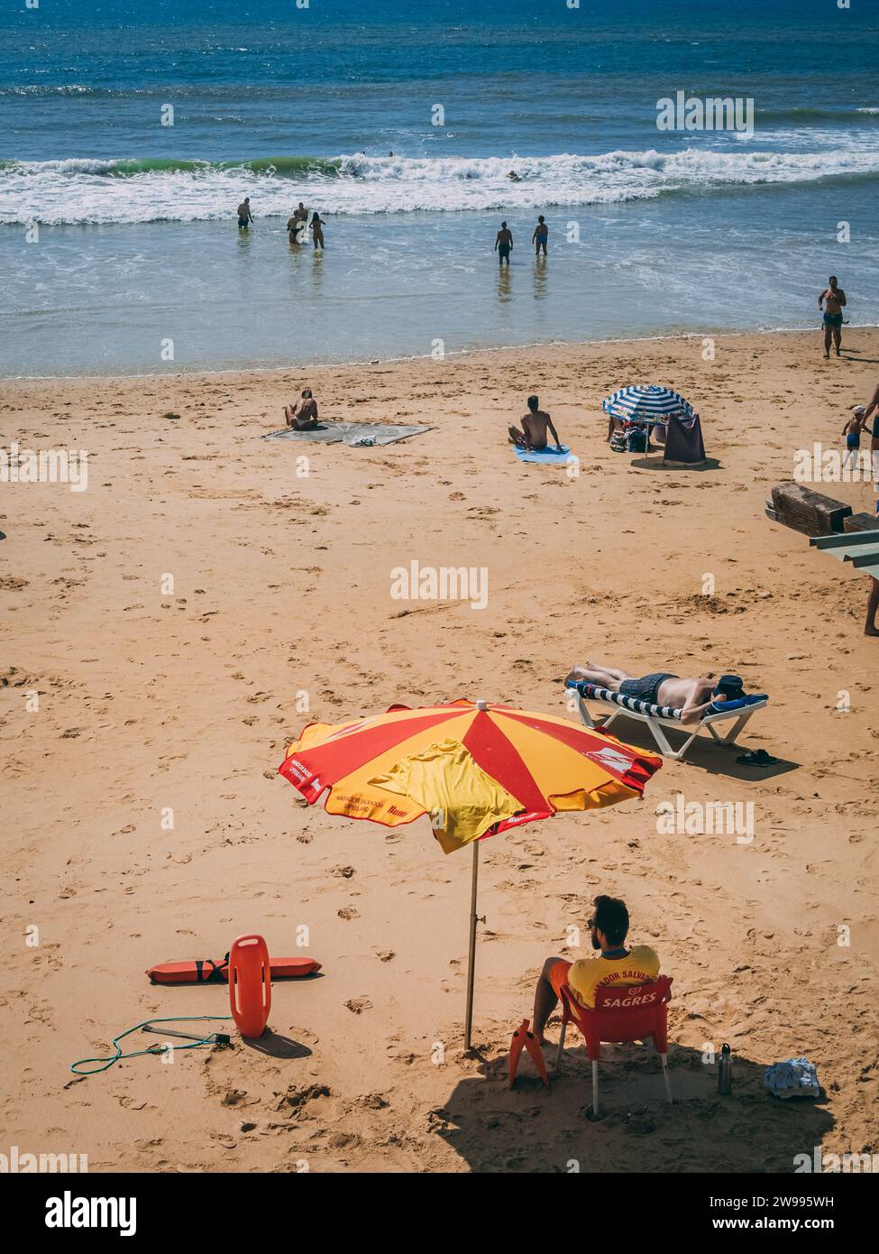 Lifeguard keeping watch on the beach at Olhos de Agua Algarve Stock ...
