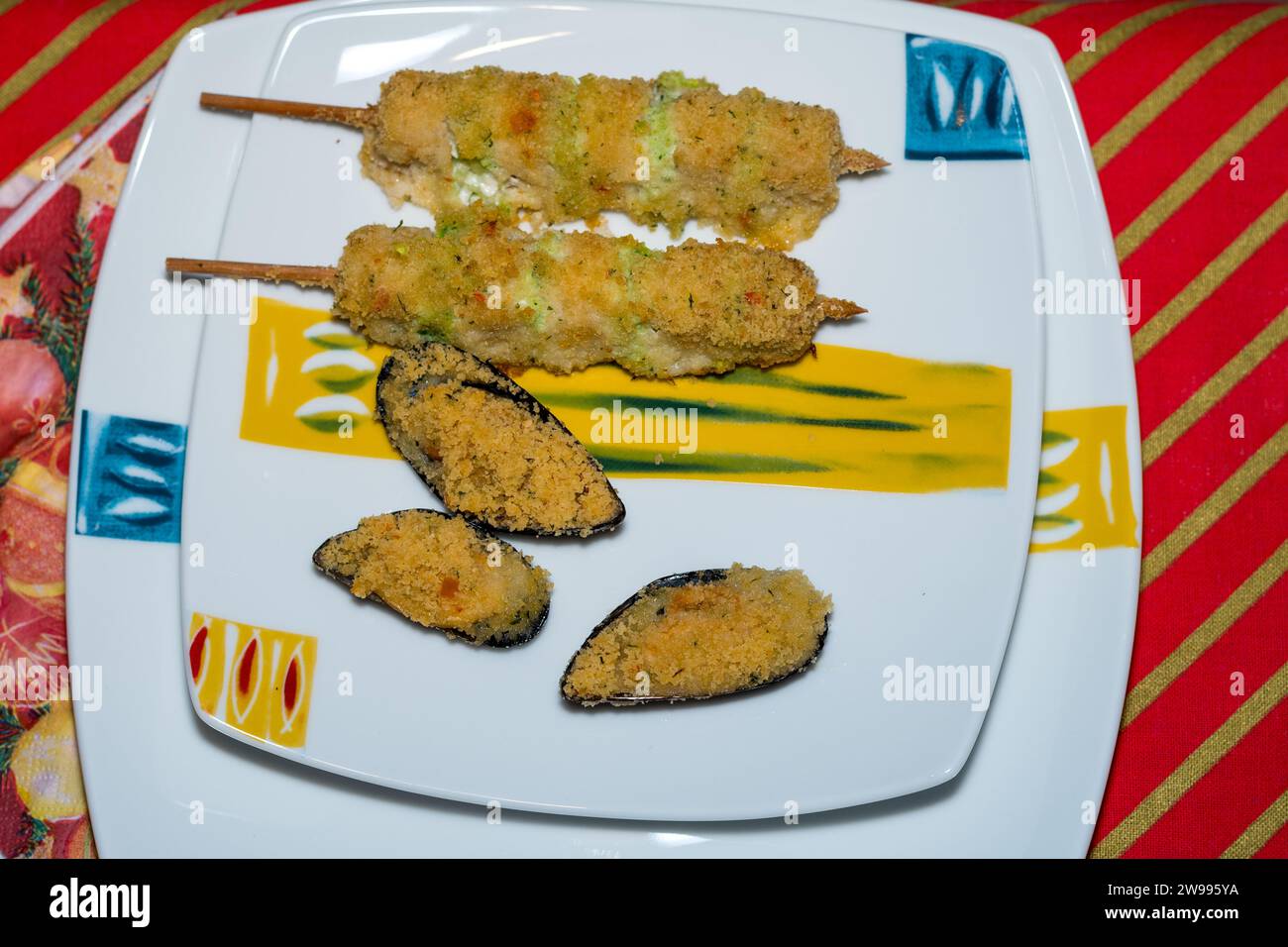 Dish taken from above with skewers of scorpion fish and courgettes and ...