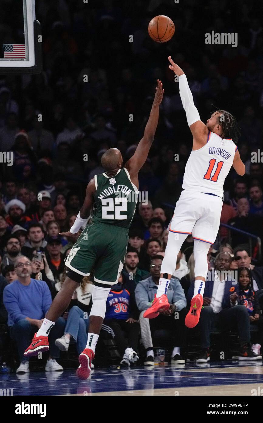 New York Knicks' Jalen Brunson, right, puts up a shot over Milwaukee ...