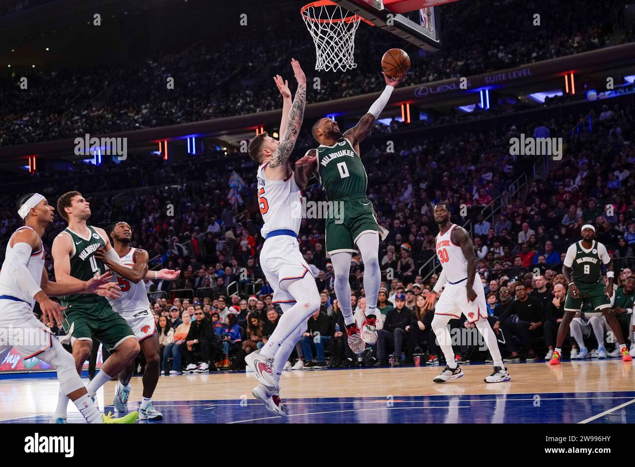Milwaukee Bucks' Damian Lillard, center right, puts up a shot past New ...