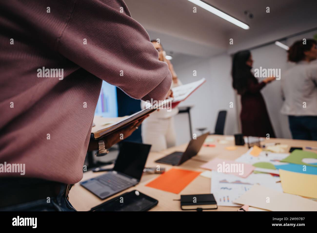 A multiracial team of professionals collaborating in a dynamic business ...