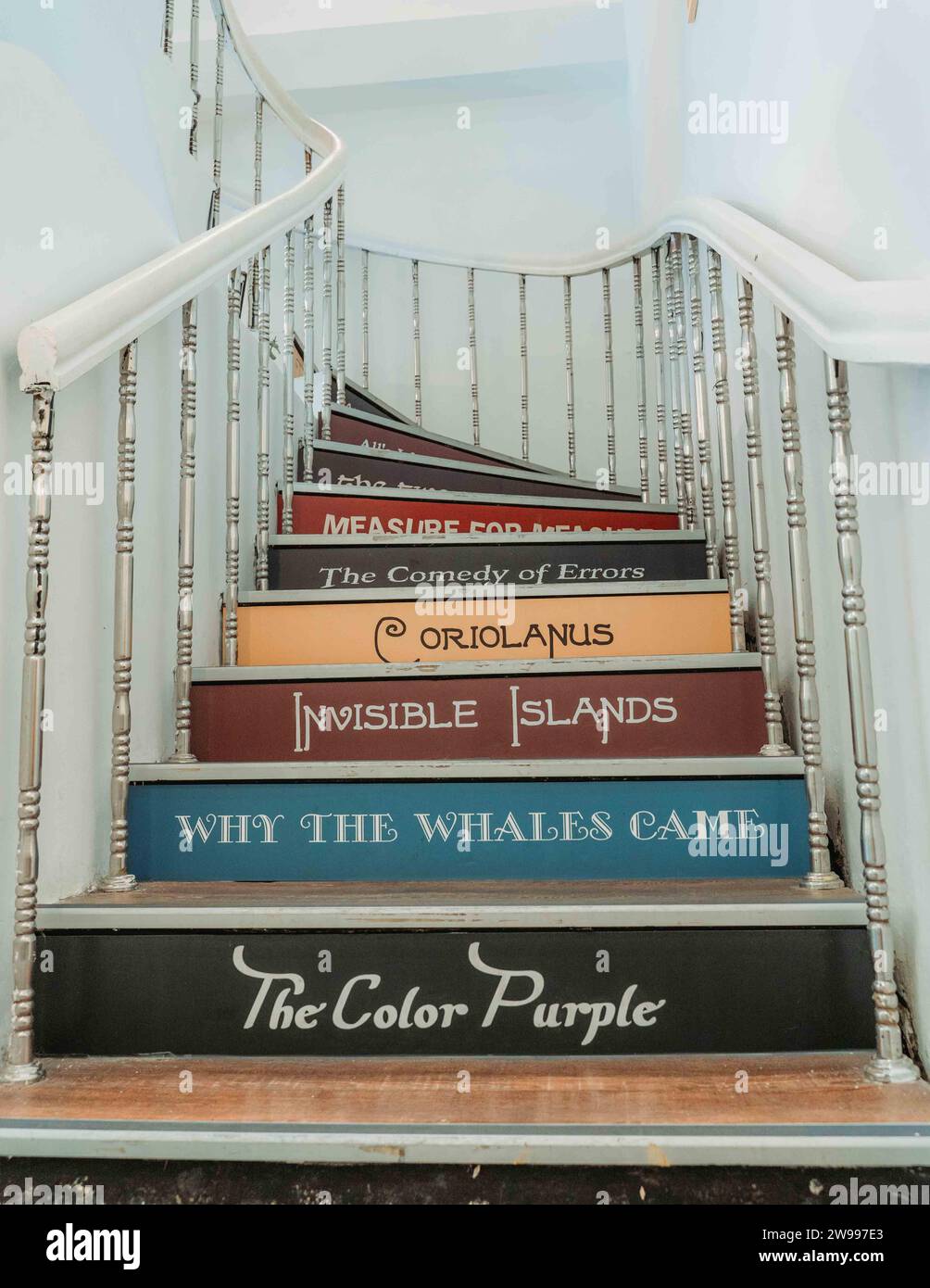 A vertical shot of steps painted with book names in a cafe in Ho Chi ...