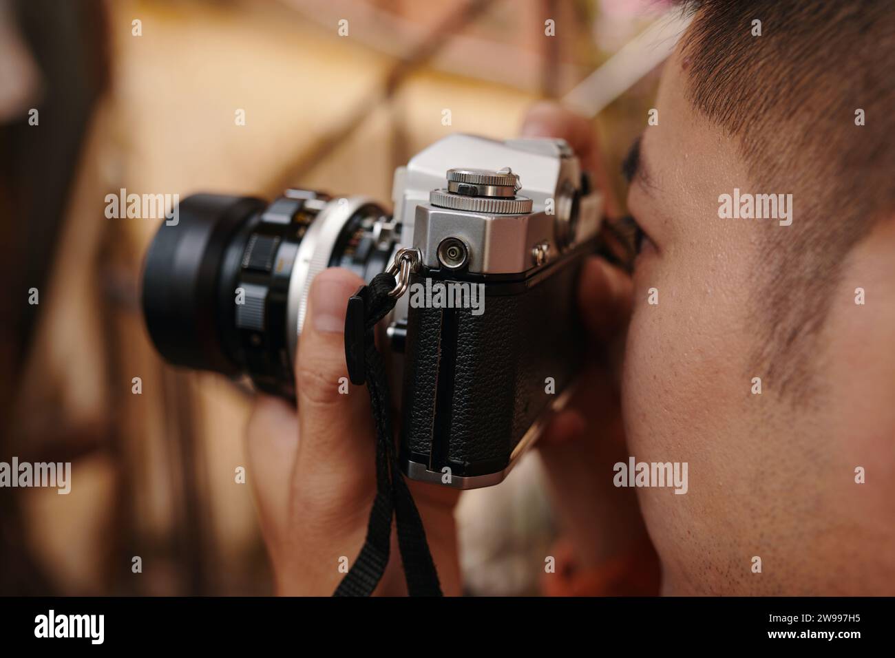 Closeup image of photographer looking through viewfinder of vintage ...