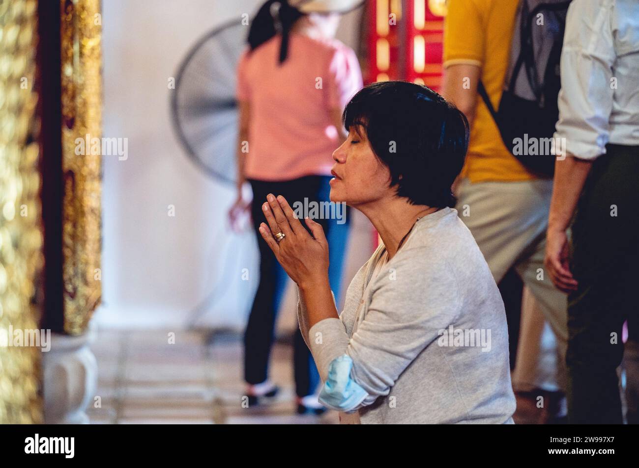 Woman praying near altar hi-res stock photography and images - Alamy