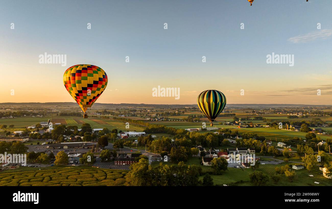 An Aerial View of Multiple Hot Air Balloons Floating Away in Rural ...