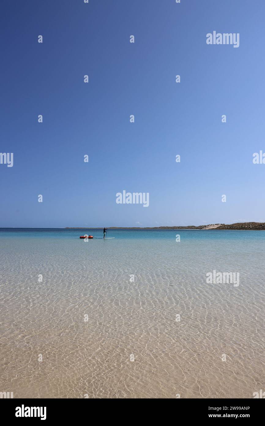 A stunning beach landscape in Coral Bay, Australia with a boat sailing ...