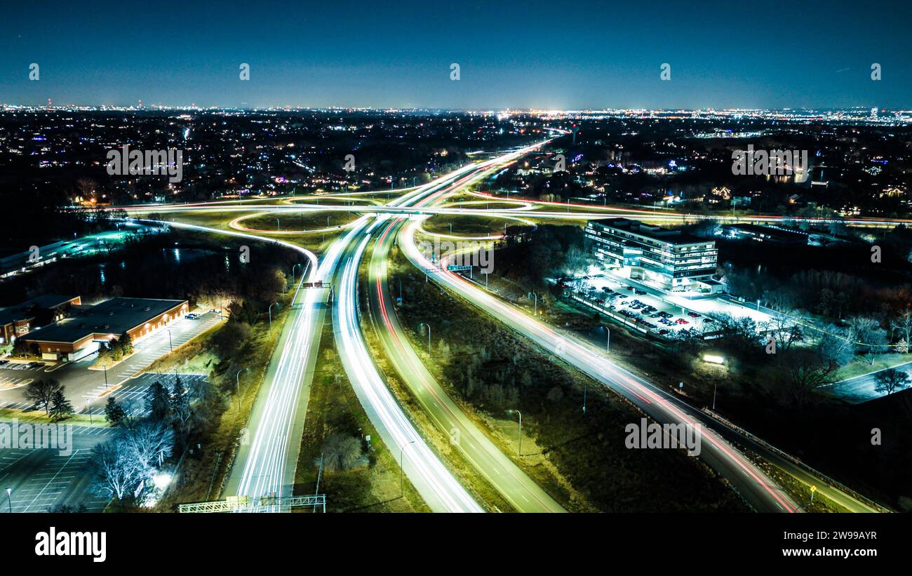 An aerial view of a highway on a moonlit night featuring red and green ...