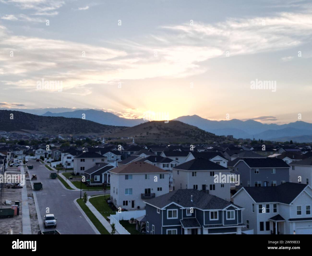 A scenic view of a residential street lined with houses and leading to ...