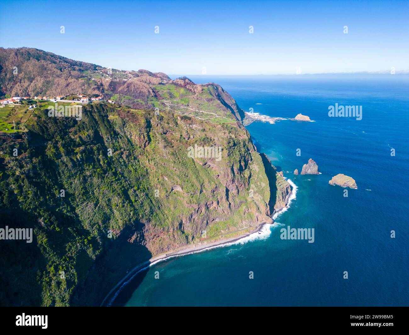 An aerial view of a stunning coastal landscape, featuring cliffs and ...