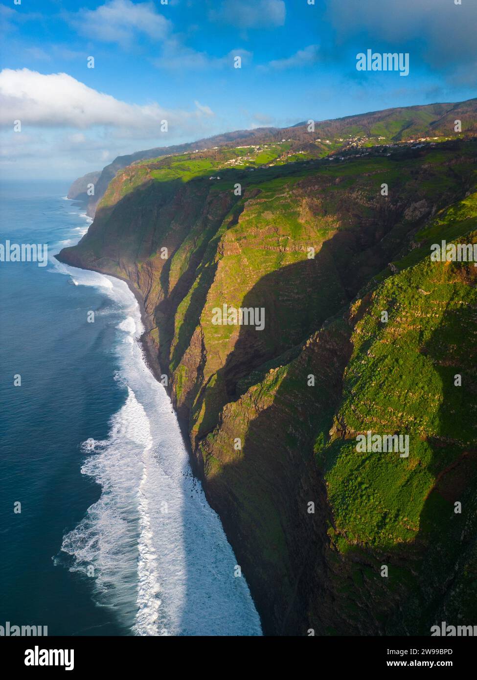 An aerial view of a stunning coastal landscape with green cliffs and ...