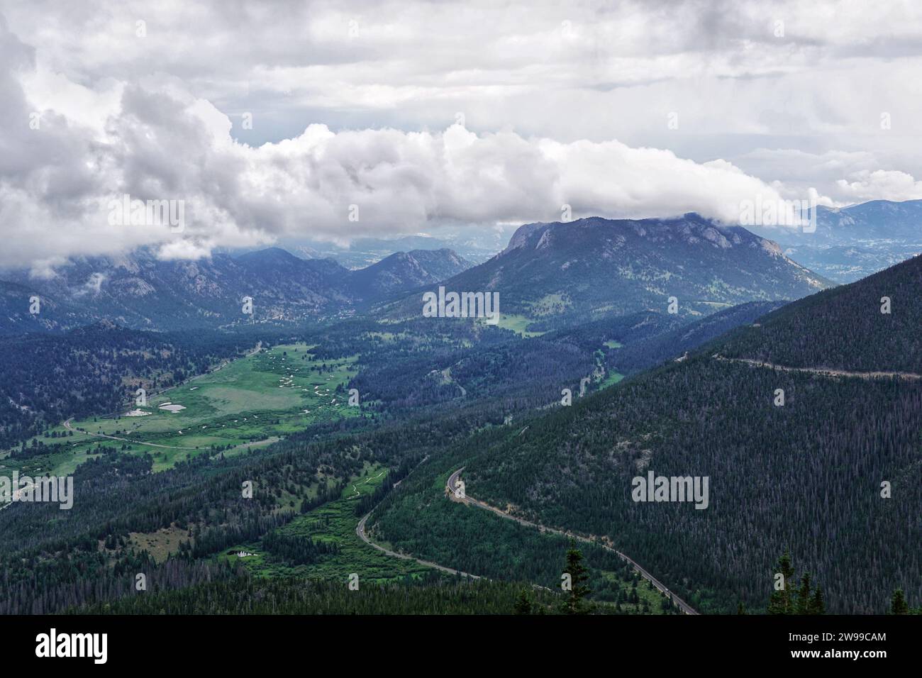 An idyllic landscape of a sunlit valley nestled in the majestic ...