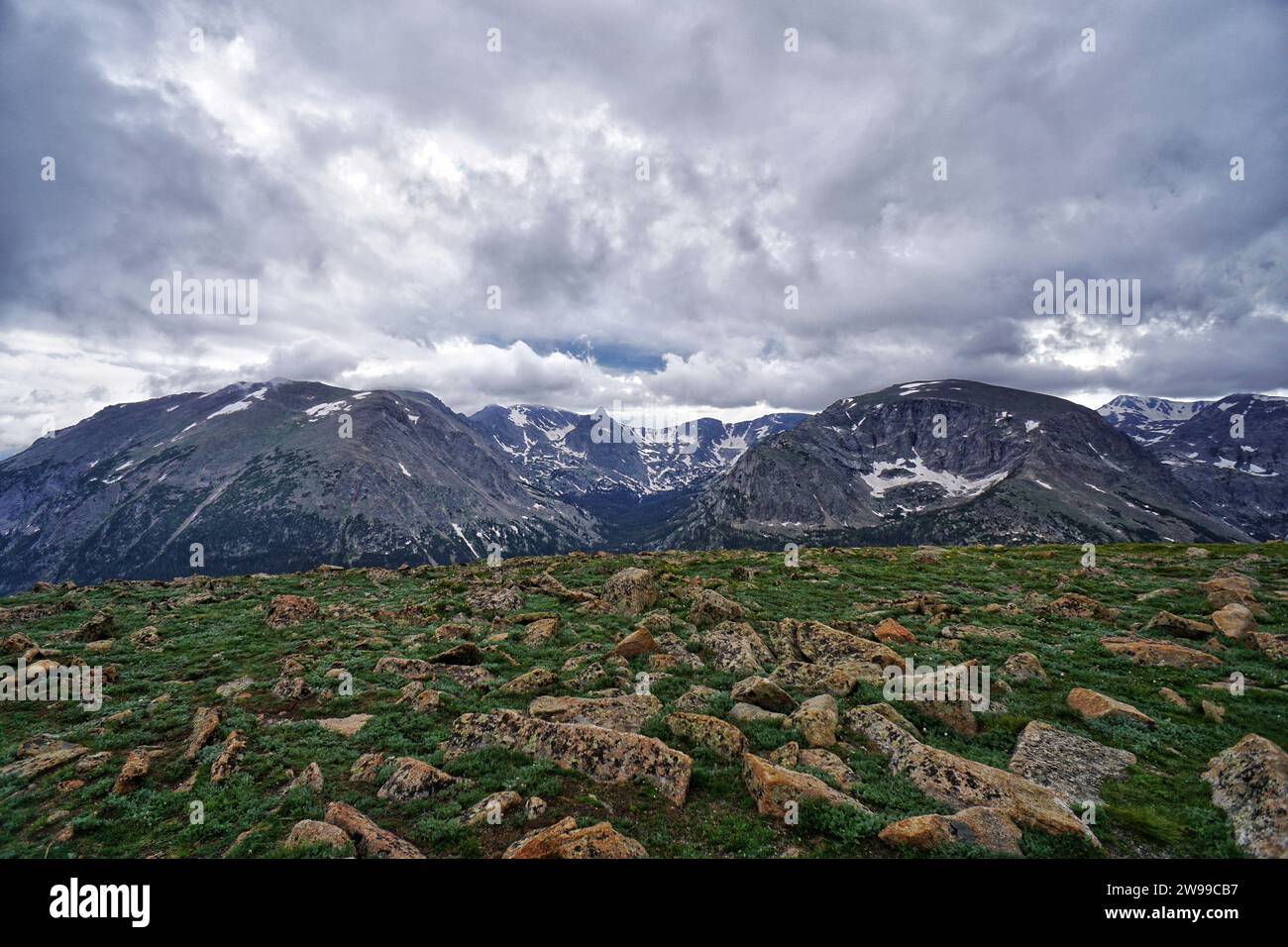 An outdoor landscape featuring a rocky field with clusters of rocks and ...