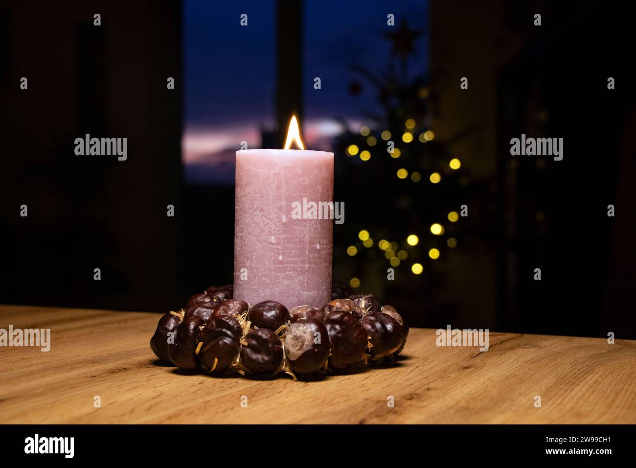 Candle open fire flame with window and christmas tree with lights in ...