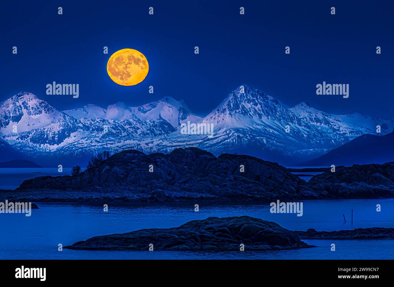 Large supermoon rising behind the majestic mountains of Lofoten ...