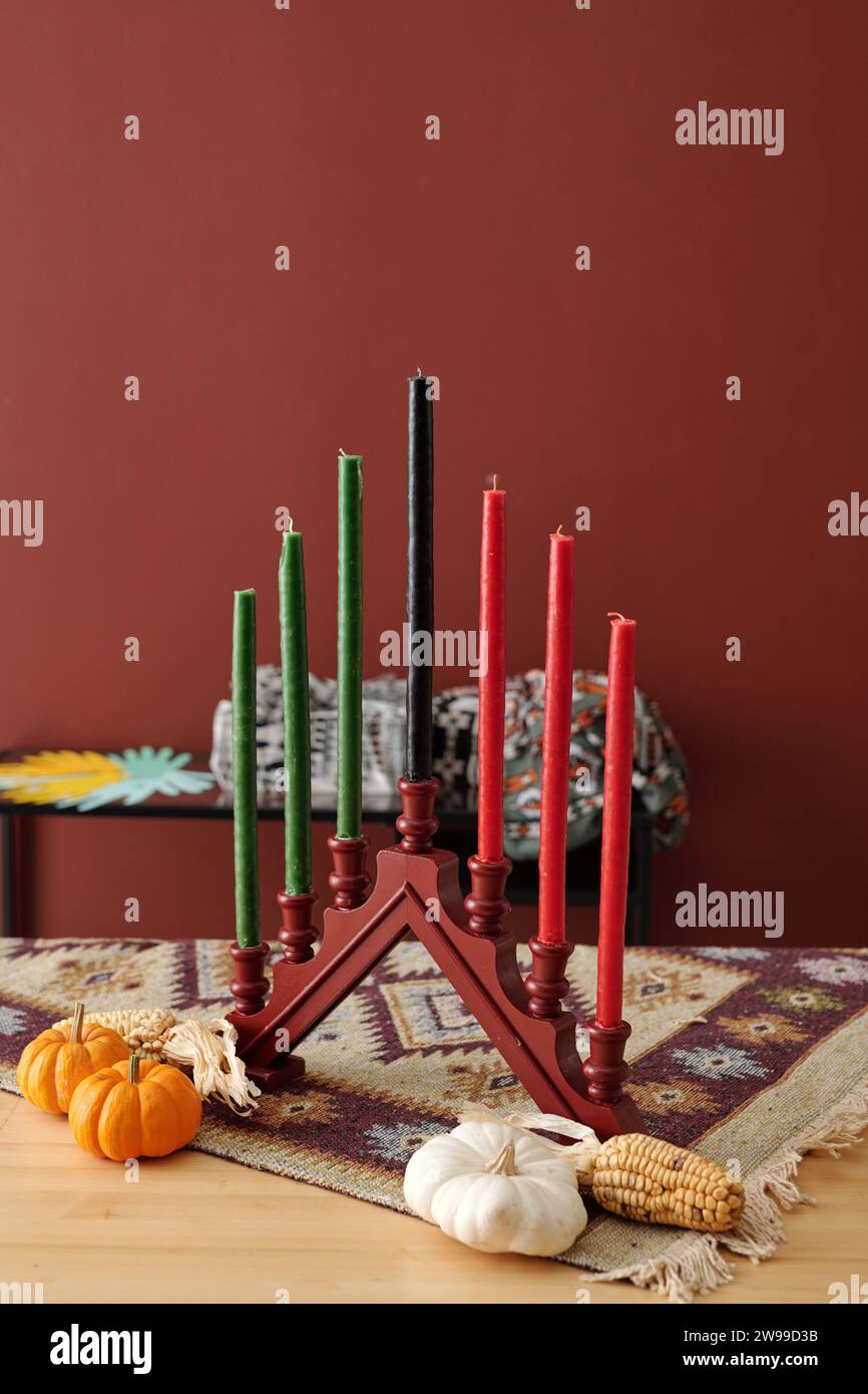 Candlestick with seven multi-colored candles and ripe vegetables ...