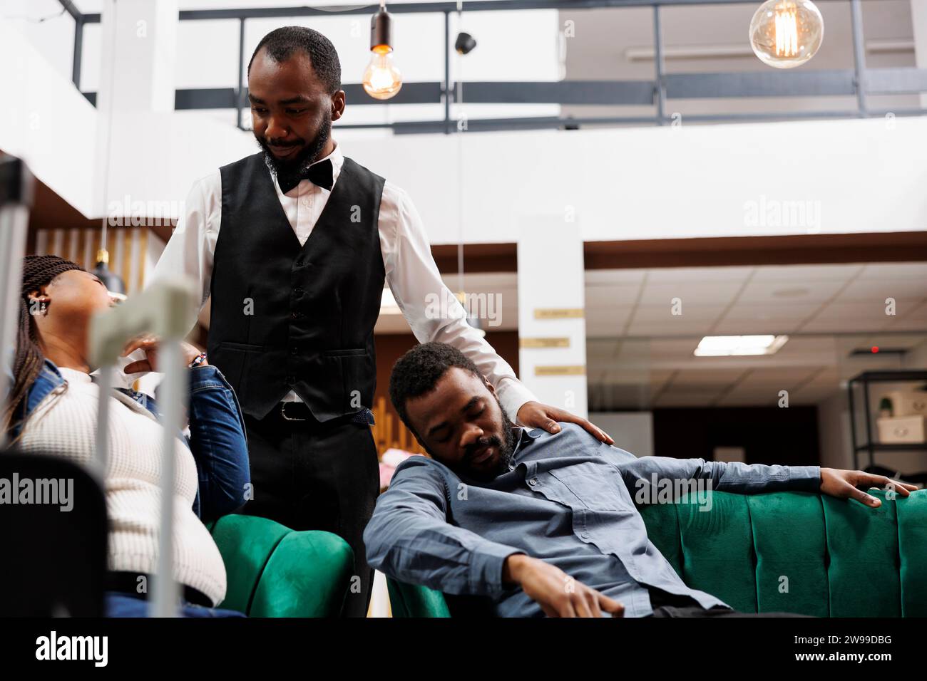 Friendly smiling African American hotel clerk in uniform waking up ...