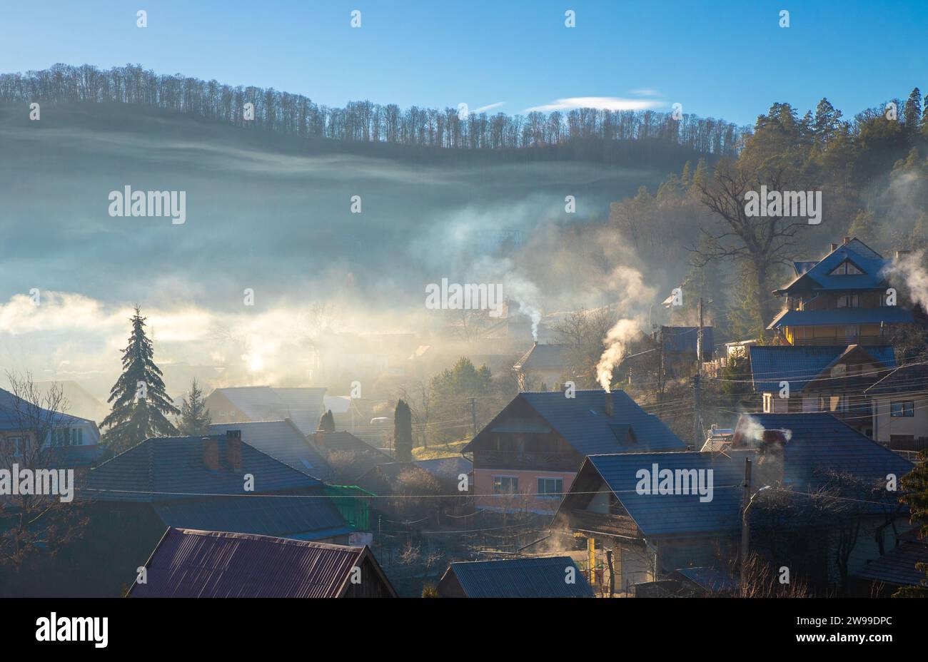 The smoke from the chimneys of the houses above the village in the ...