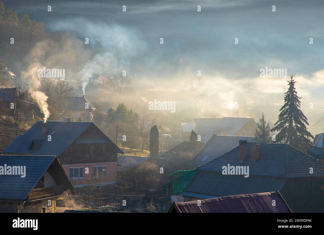 The smoke from the chimneys of the houses above the village in the ...