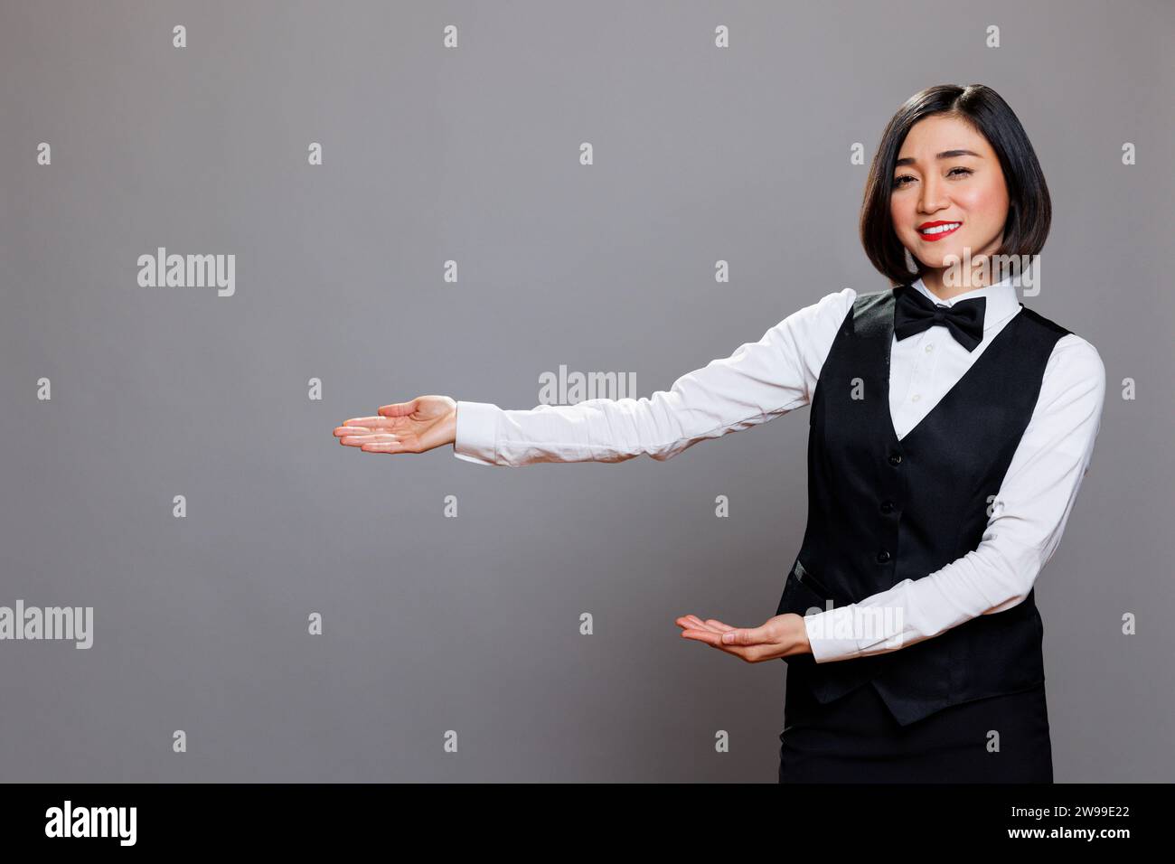 Catering service asian woman employee pointing with hands to right ...