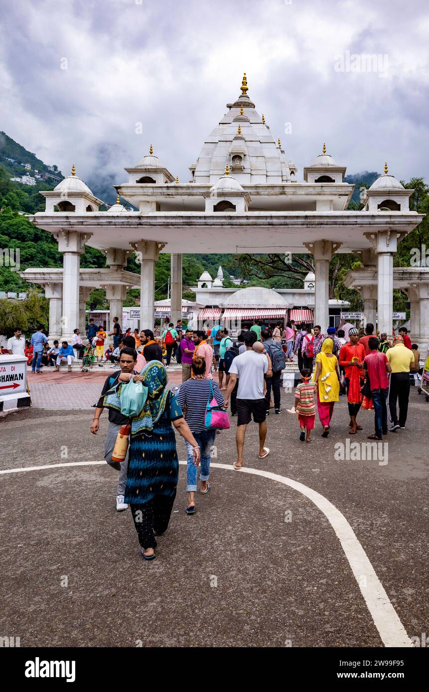 A group of people walking towards the magnificent entrance of a temple ...