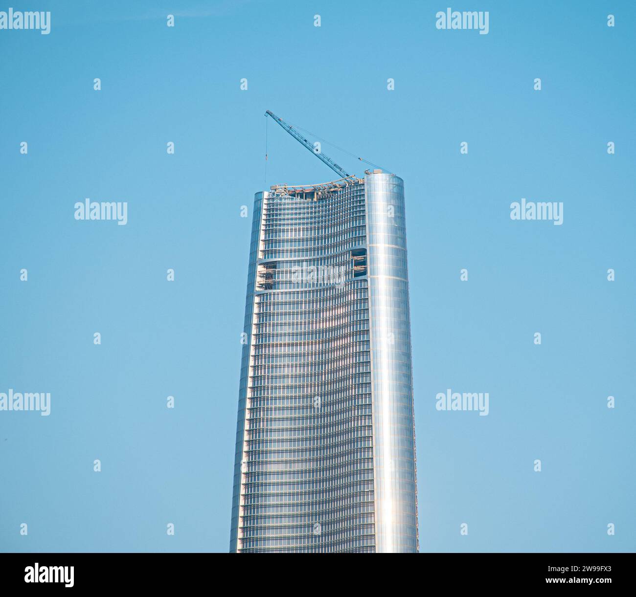 A tall building with a tower reaching up towards it Stock Photo - Alamy