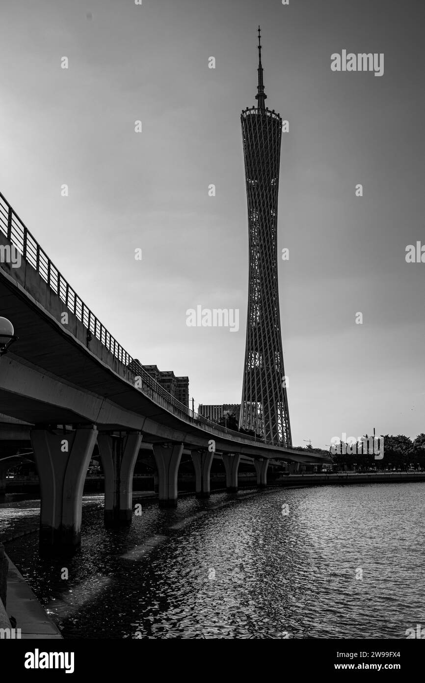 A black and white photograph of a bridge with a walkway underneath ...