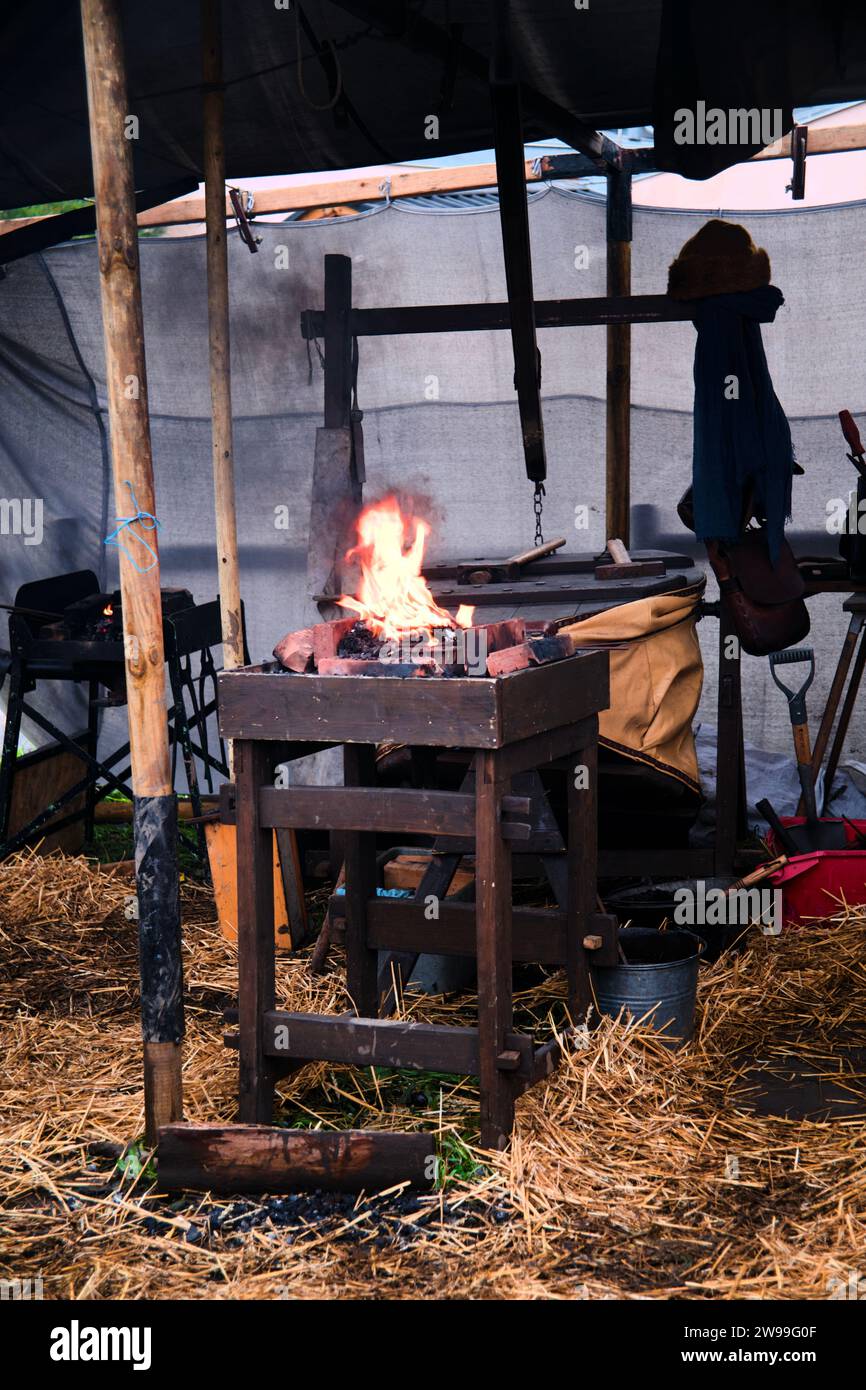 A campfire burning brightly with sparks rising up against a backdrop of ...