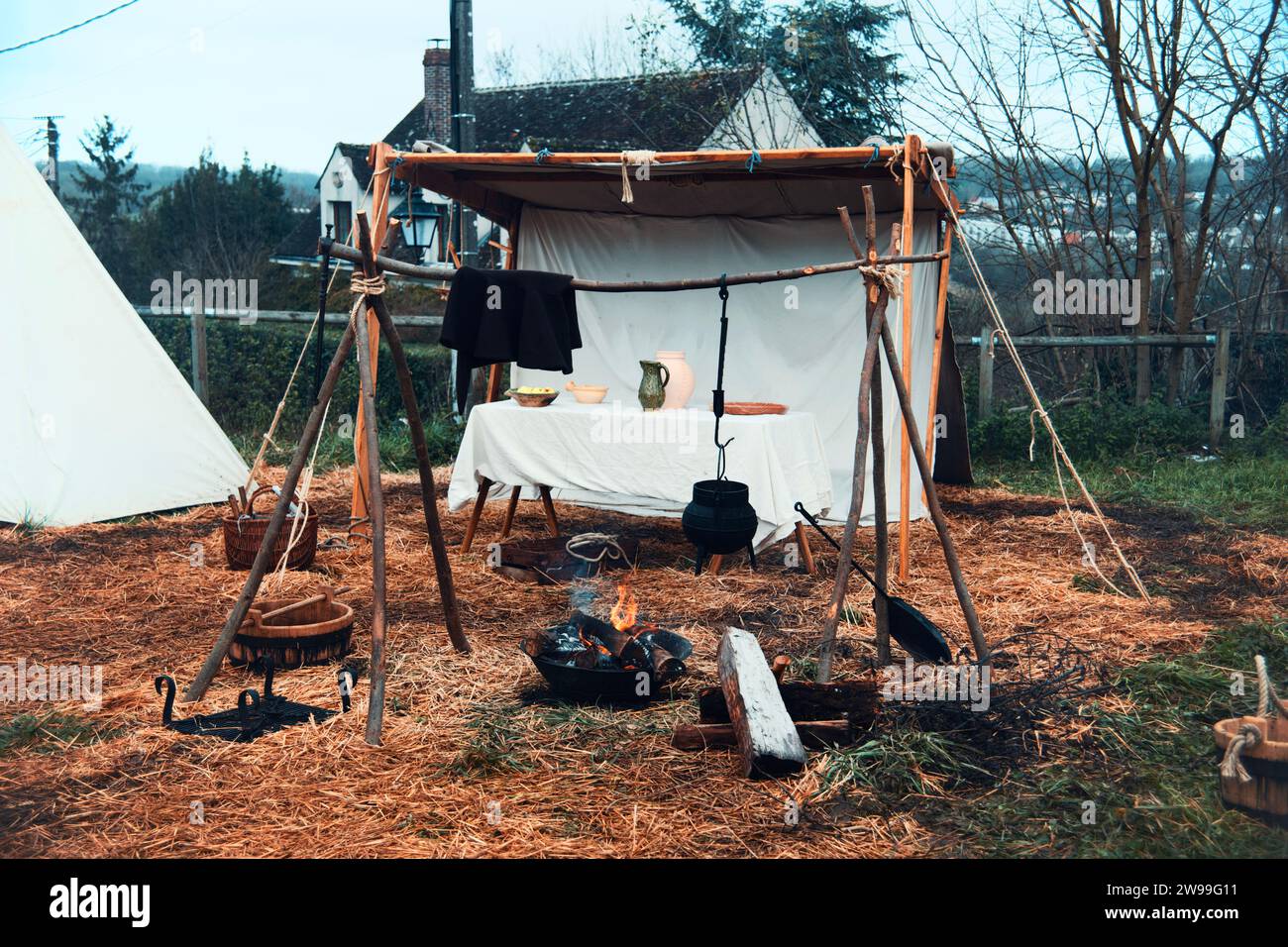 A camping scene featuring an olive green, two-person tent with white ...