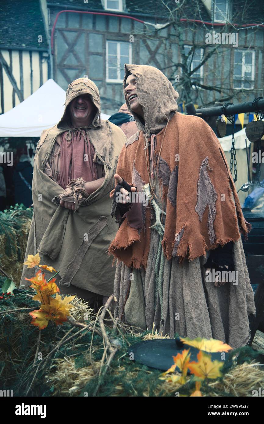 Two men wearing traditional Medieval attire engaged in conversation ...