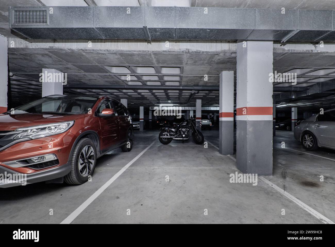 Underground garage of a residential building with several empty spaces ...