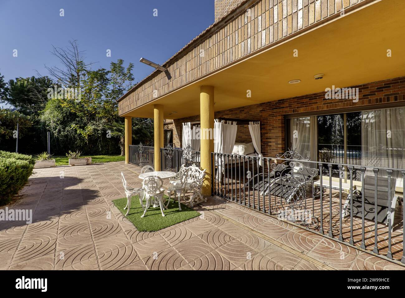 a luxury single-family house with large gardens and a porch with a ...