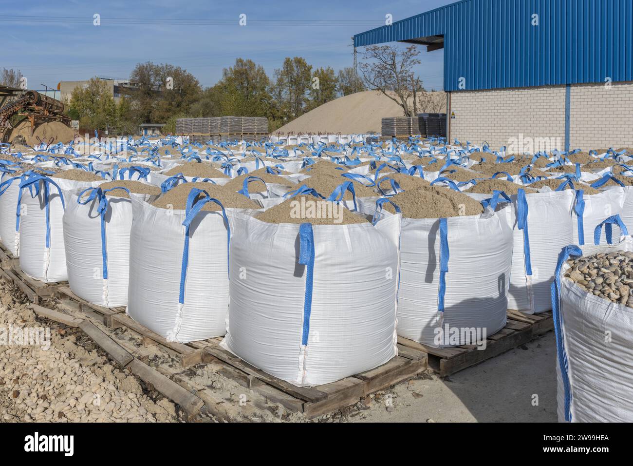 A pile of large raffia bags filled with sand for construction work ...