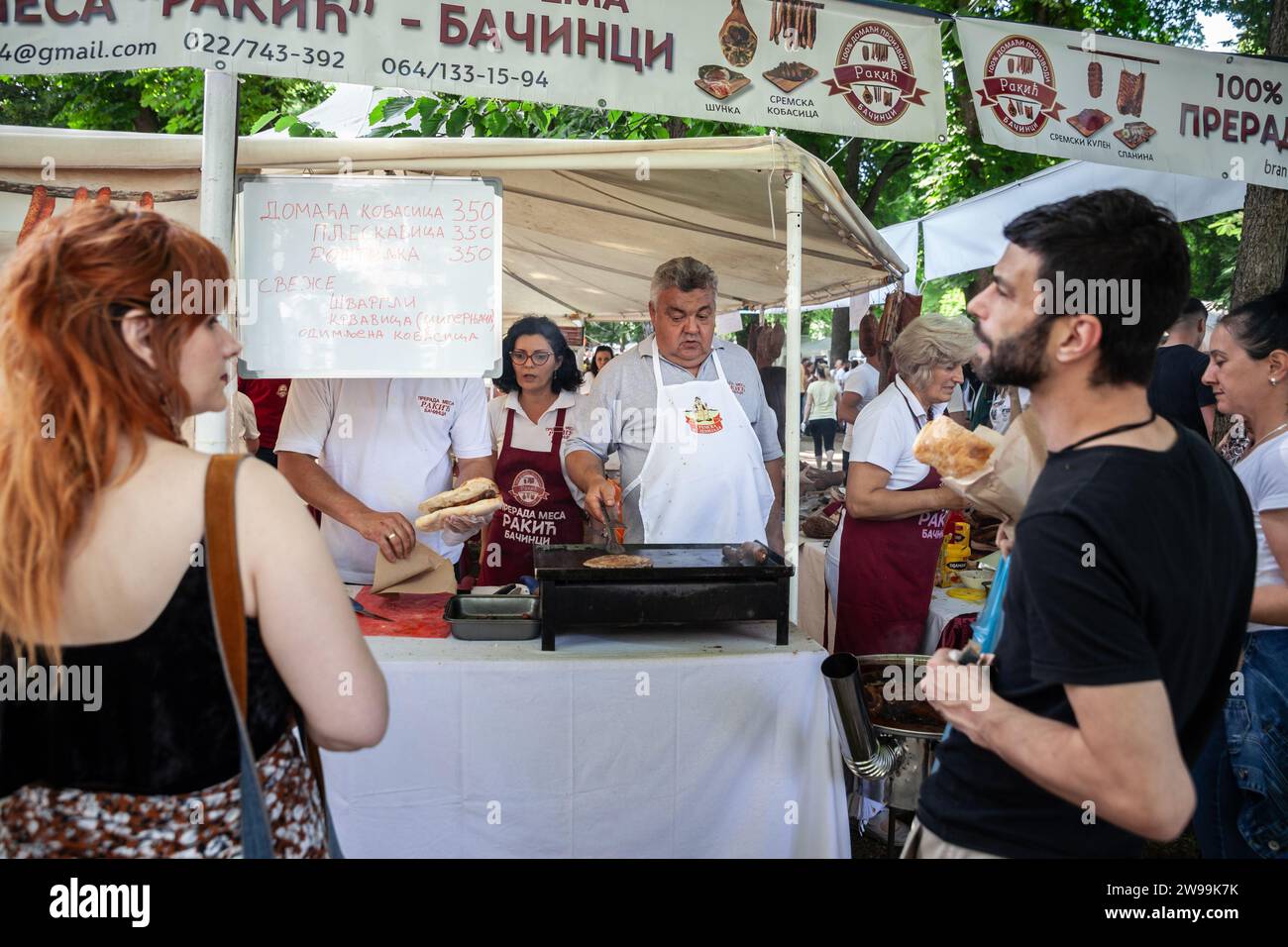 Picture of Serbs grilling meat on a barbecue in a market of Erdevik ...