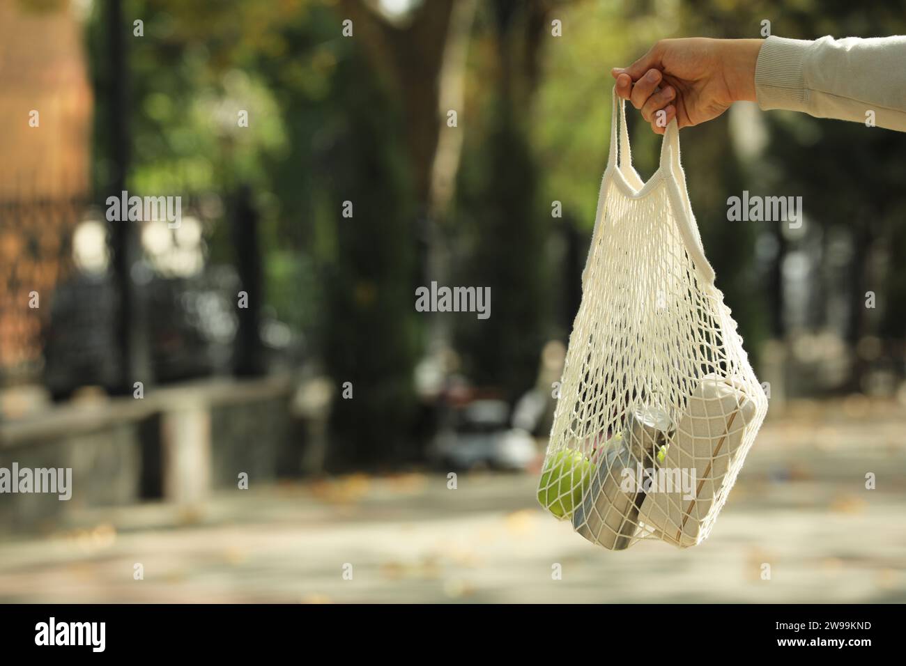 Conscious consumption. Woman with net bag of eco friendly products ...