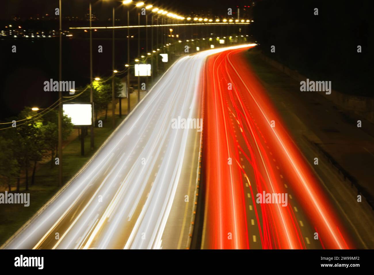 Road traffic, motion blur effect. View of car light trails at night ...